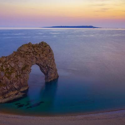 A rock on the shore of the beach with an arch-shaped ledge - KDE Store