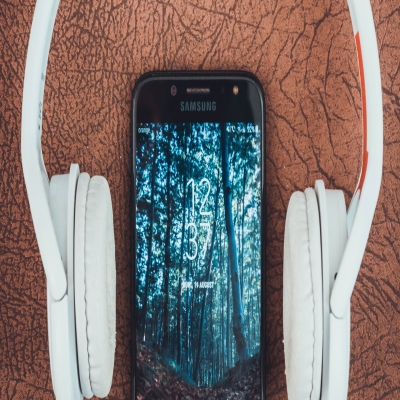 Turned-on Black Samsung Smartphone Between Headphones - KDE Store